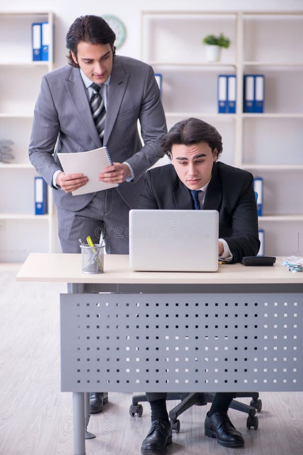 Two Young Employees Working in the Office Stock Image - Image of ...