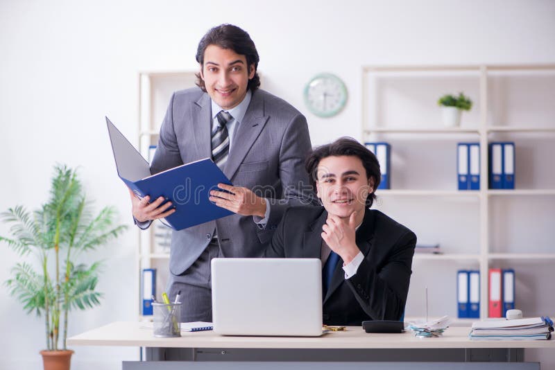 Two Young Employees Working in the Office Stock Photo - Image of ...