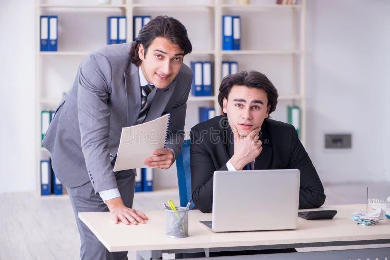 Two Young Employees Working in the Office Stock Image - Image of ...