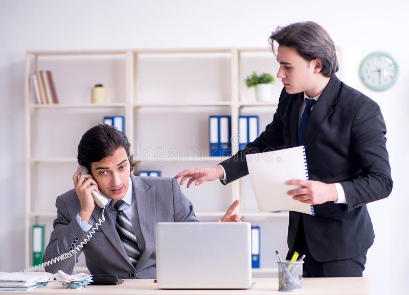 Two Young Employees Working in the Office Stock Photo - Image of ...