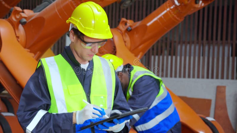Two Young Engineer Man Checking and Maintenance Machine Robot Arms ...