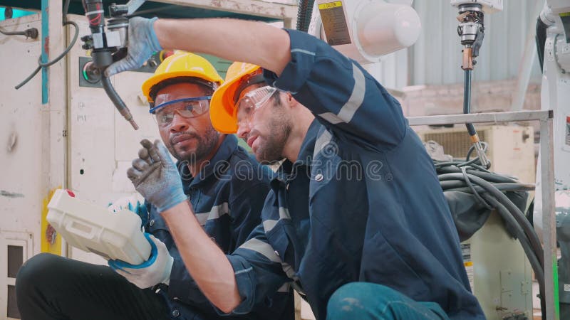 Two Young Engineer Man Talking and Explaining about Robot Arms ...