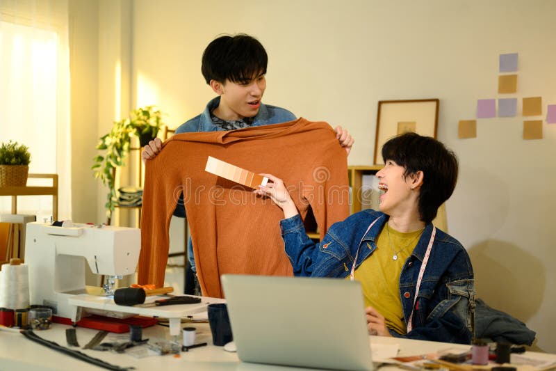 Two Young Fashion Designers Comparing Fabric Colors in a Creative Studio Stock Image - Image of ...