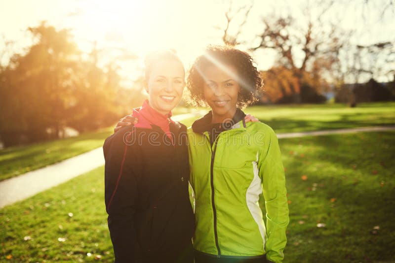 Two Young Female Athletes Hugging while Standing in Park Stock Image ...