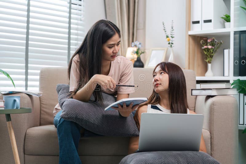Young Female Friends Studying Together and Taking Online Exams in a Cozy Home Environment with ...