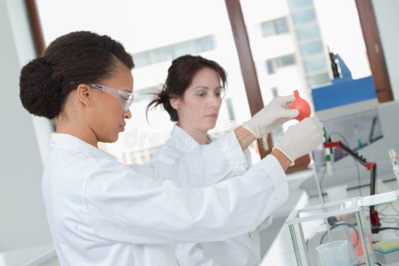 Two Young Female Scientist Doing Experiments in Lab Stock Image - Image ...