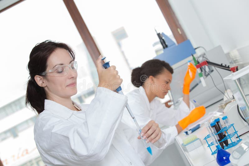 Two Young Female Scientist Doing Experiments in Lab Stock Image - Image ...