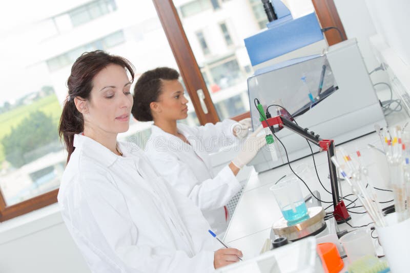Two Young Female Scientist Doing Experiments in Lab Stock Image - Image ...