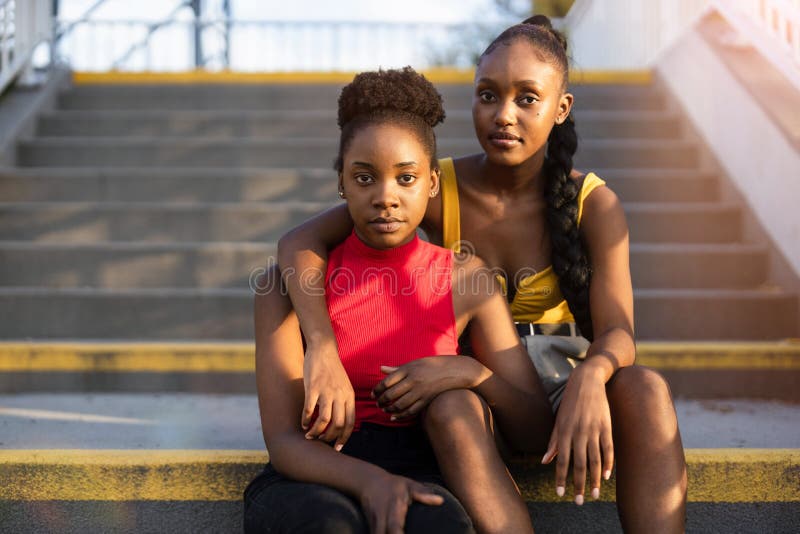 Two Young Female Sitting on the Stairs Stock Image - Image of black ...