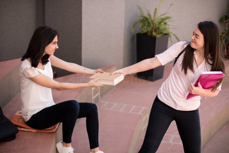 Two Young Female Students Fighting Over the Learning Material Stock ...