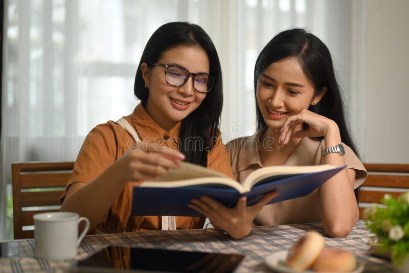 Two Young Female Students Preparing a Report, Discuss Studying Issues ...