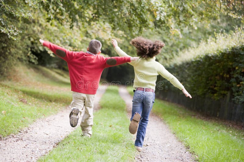 Two Young Children Running on Path Smiling Stock Image - Image of ...
