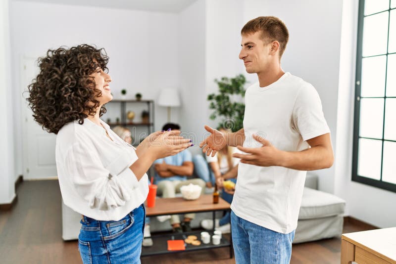 Two Young Friends Standing and Speaking at Home Stock Photo - Image of ...