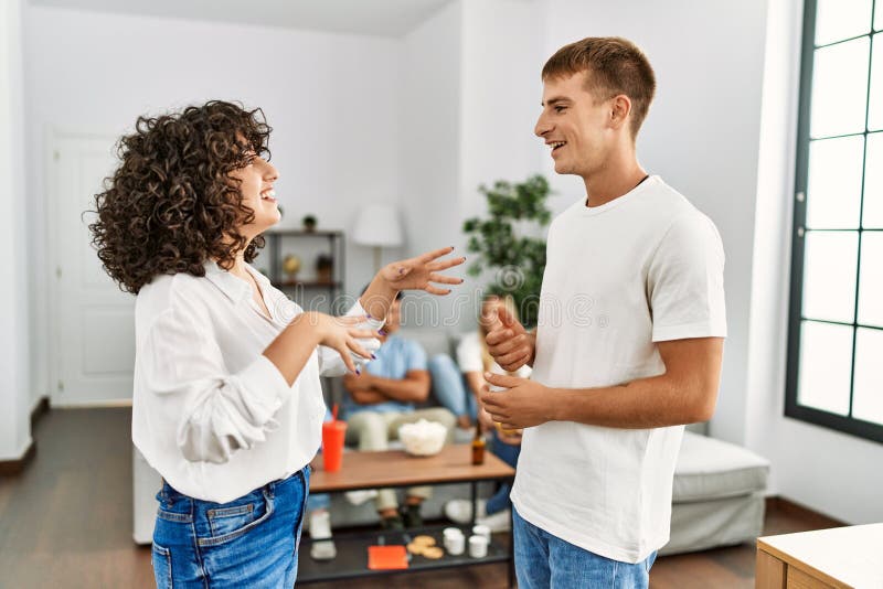 Two Young Friends Standing and Speaking at Home Stock Image - Image of ...