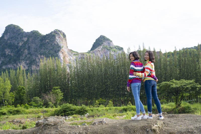 Two Young Girl Have Fun at Beautiful Landscape View of Mountain and ...