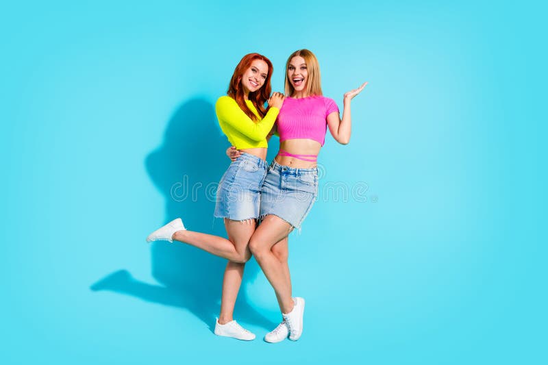 Cheerful Young Girlfriends Posing in Colorful Casual Outfits Against a ...