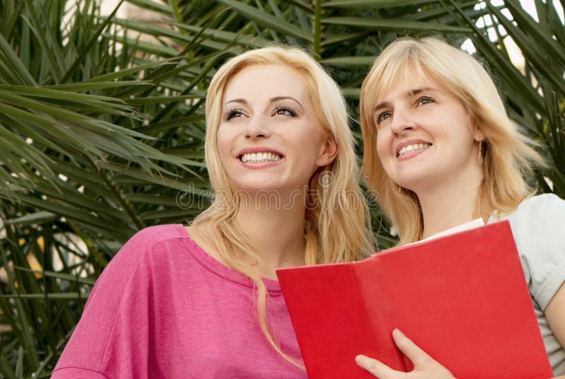 Two Young Girls with the Book Stock Photo - Image of holding, friendly ...