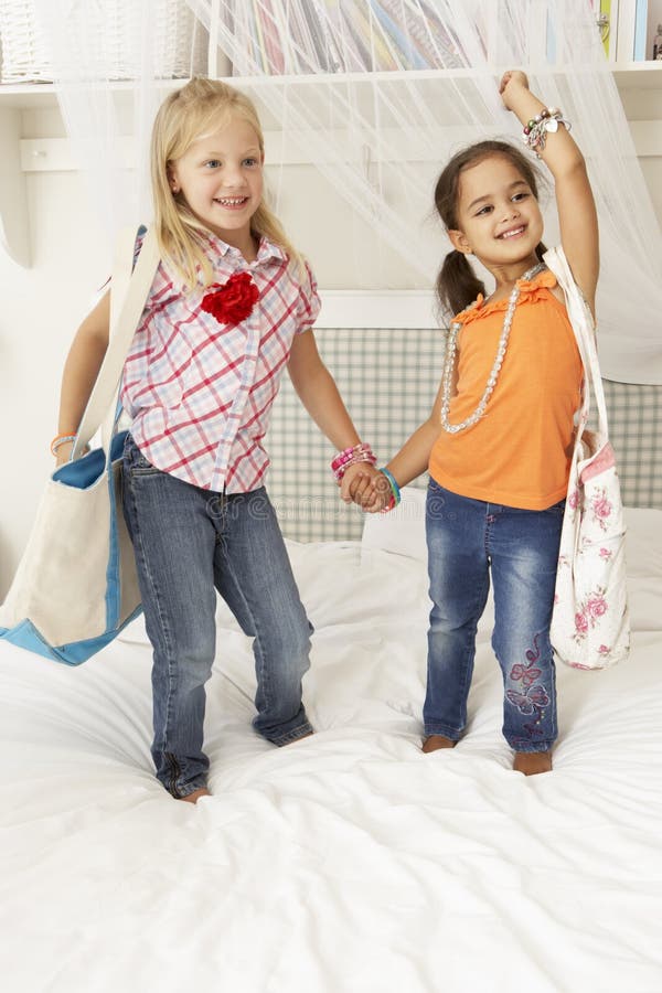 Two Young Girls Dressing Up Together in Bedroom Stock Photo - Image of ...