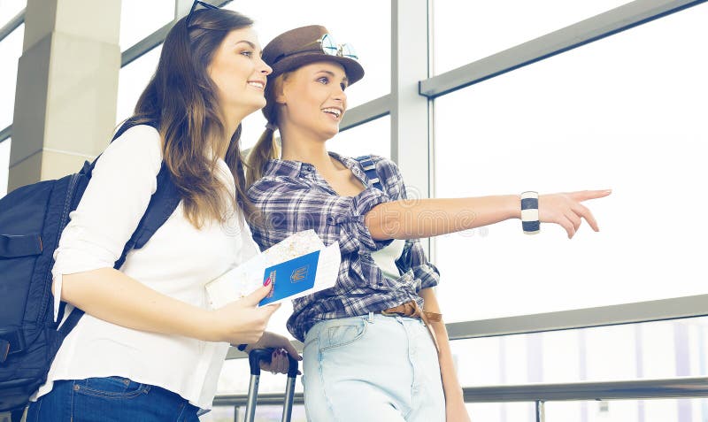 Two Young Girls Look at the Map and Show the Direction of the Index ...
