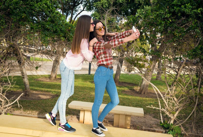Two young girls in park stock photo. Image of teenagers - 72481368