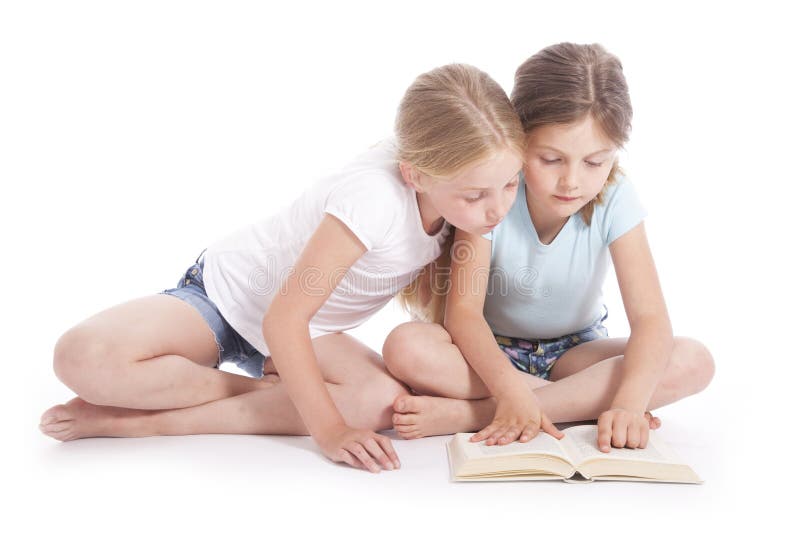 Two Young Girls Reading A Book Together Stock Image - Image of book ...