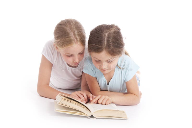 Two Young Girls Reading A Book Together Stock Image - Image of cute ...