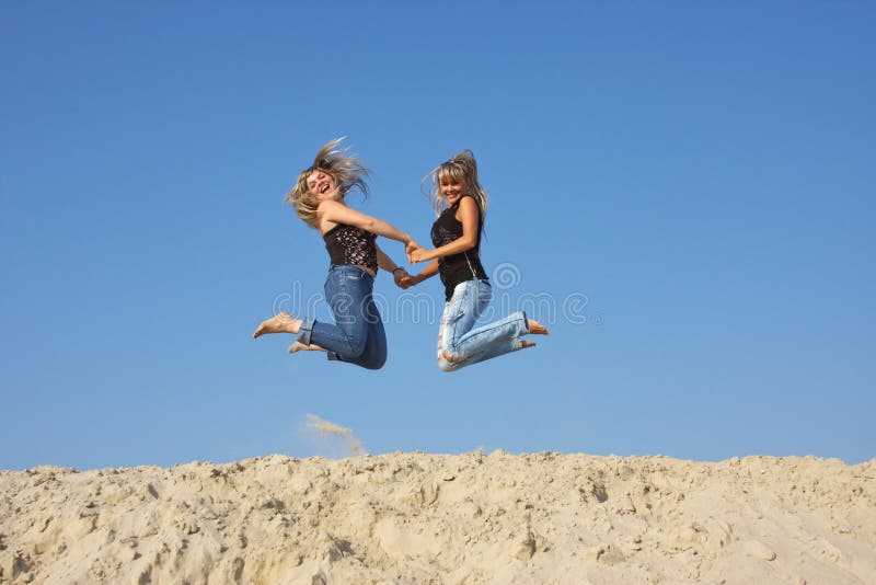 Two Young Girls on a Sand-pit Stock Photo - Image of blue, woman: 16703294