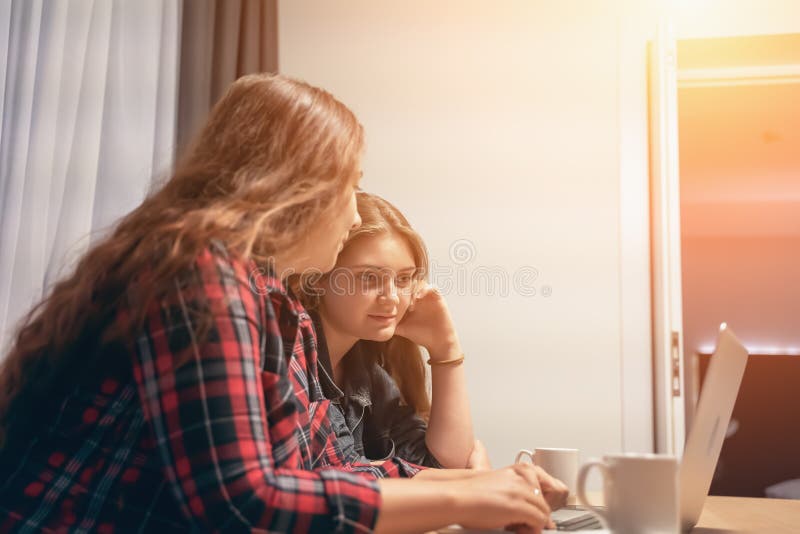 Two Young Girls Seat at Home at Laptop, Distant Collaboration Working ...
