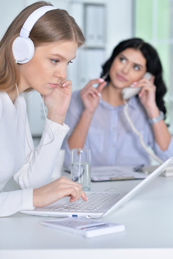 Two young girls working stock photo. Image of modern - 85844134