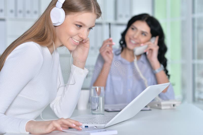 Two young girls working stock image. Image of progress - 87375041