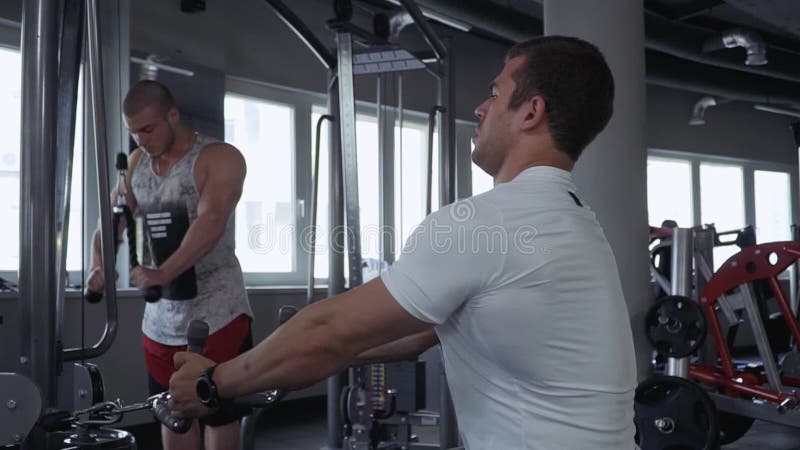 Two young guys in the gym stock video. Video of fitness - 127708171