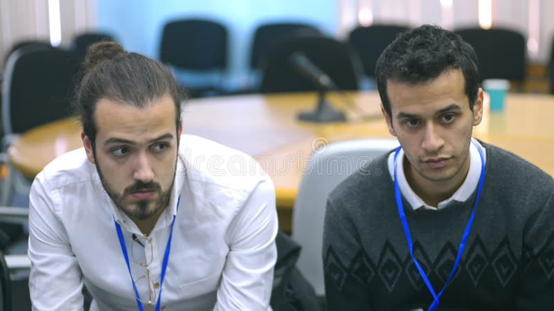 Two Young Guys are Sitting in Classroom while Studying at Academic ...