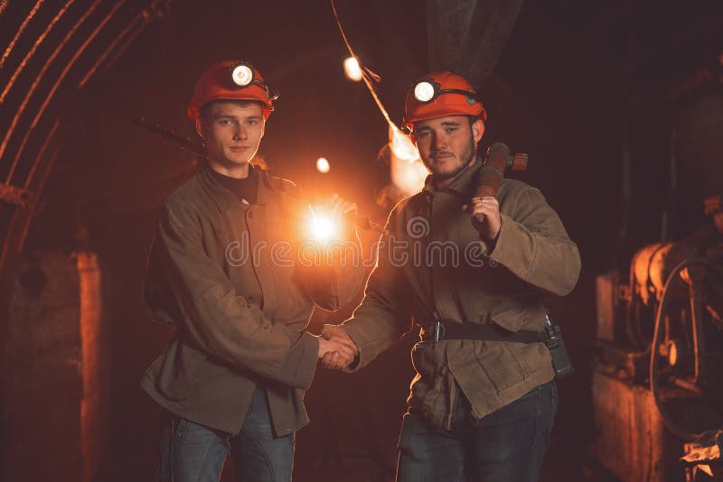 Two Young Guys in Special Clothes and Helmets Standing in the Mine ...