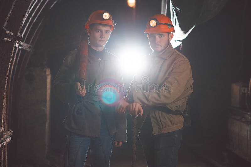 Two Young Guys in Special Clothes and Helmets Standing in the Mine ...