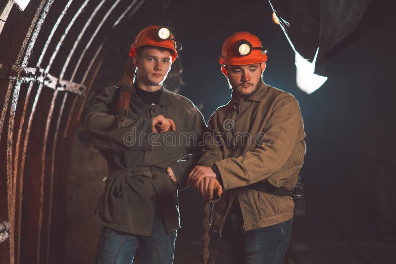 Two Young Guys in Special Clothes and Helmets Standing in the Mine ...