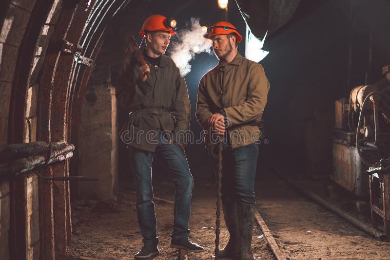 Two Young Guys in Special Clothes and Helmets Standing in the Mine ...