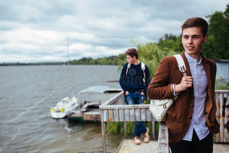 Two Young Guys Standing on a Pier Stock Photo - Image of bags, nature ... Two Young Guys Standing on a Pier Stock Photo - Image of bags, nature ...