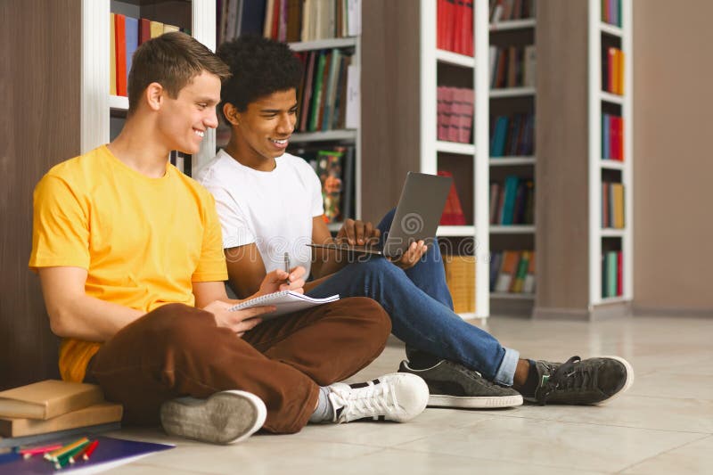 Two Young Guys Studying on Floor in Library Stock Image - Image of ...