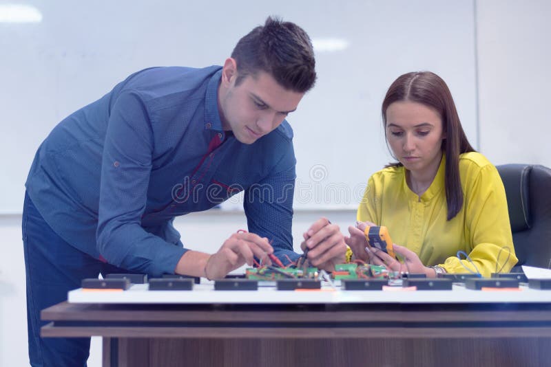 Two Young Handsome Engineers Working on Electronics Components.Tech ...