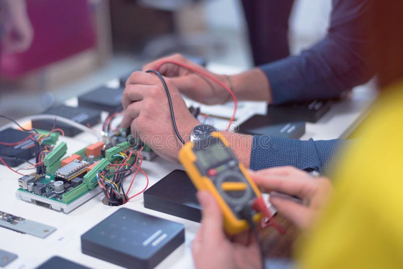 Two Young Handsome Engineers Working on Electronics Components.Tech ...