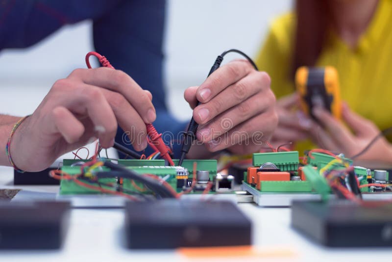 Two Young Handsome Engineers Working on Electronics Components.Tech ...