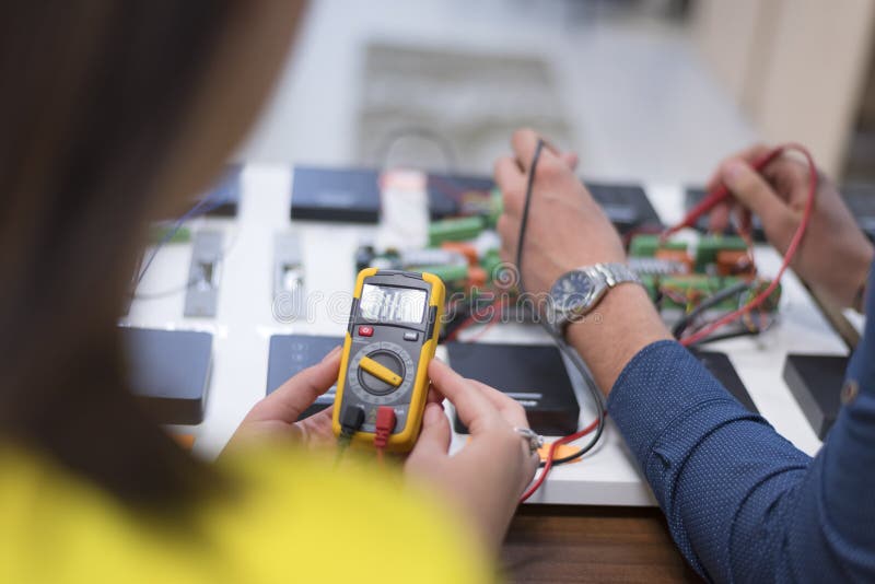 Two Young Handsome Engineers Working on Electronics Components.Tech ...