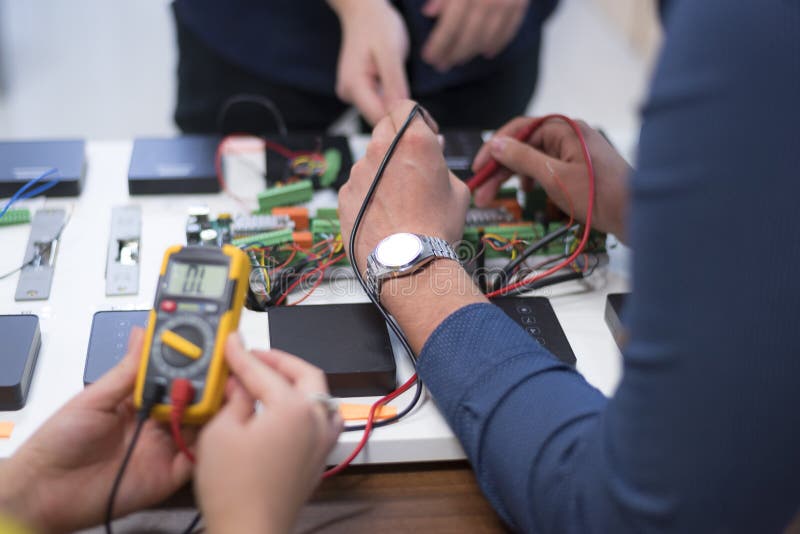 Two Young Handsome Engineers Working on Electronics Components.Tech ...