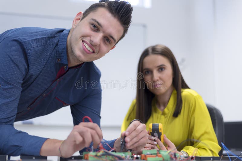Two Young Handsome Engineers Working on Electronics Components.Tech ...