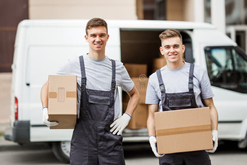 Two Young Handsome Smiling Workers Wearing Uniforms are Standing in ...