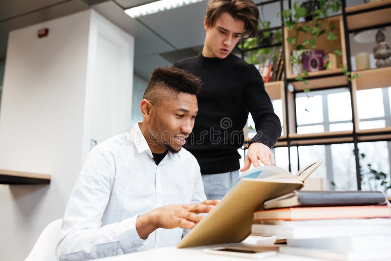 Two Young Handsome Students in Library Learning Education Material ...