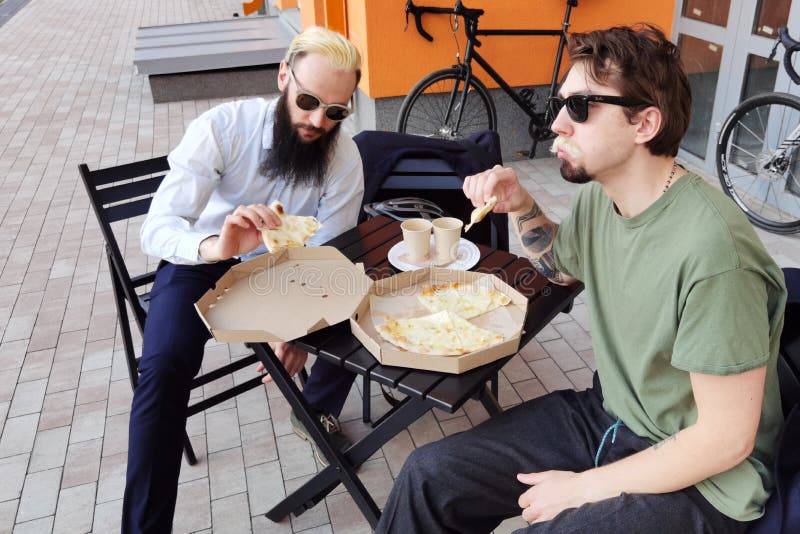 Two Young Hipster Guy Sitting in a Cafe Chatting and Drinking Coffee ...