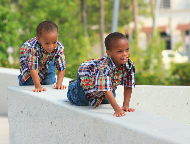Two Young Kids Crawling on Ledge Stock Photo - Image of play, identical ...