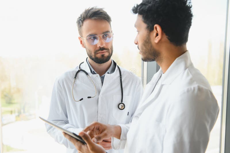 Two Young Male Doctors in the Clinic Stock Image - Image of smiling ...