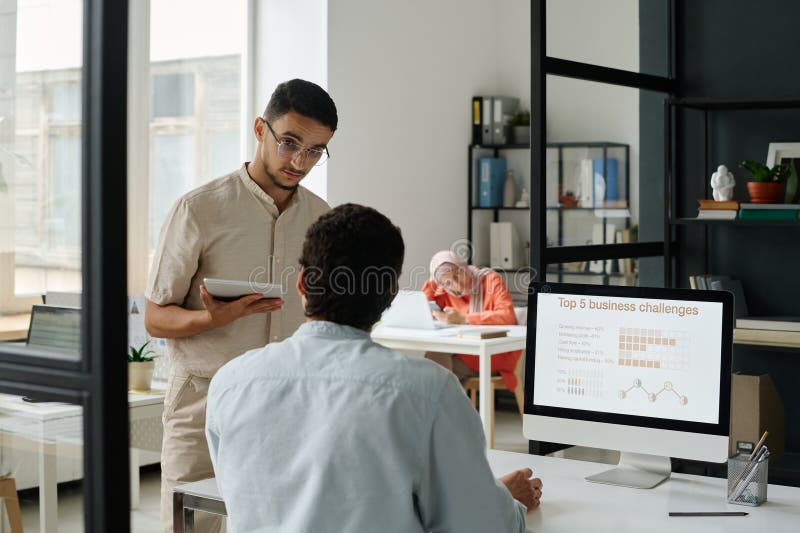 Young Businessmen Having Discussion Stock Photo - Image of report ...